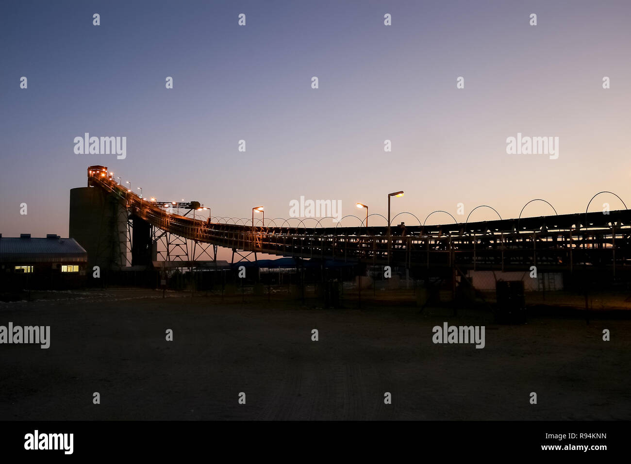 Silhouette of a mining silo and conveyor belts on a Platinum Mine Stock ...