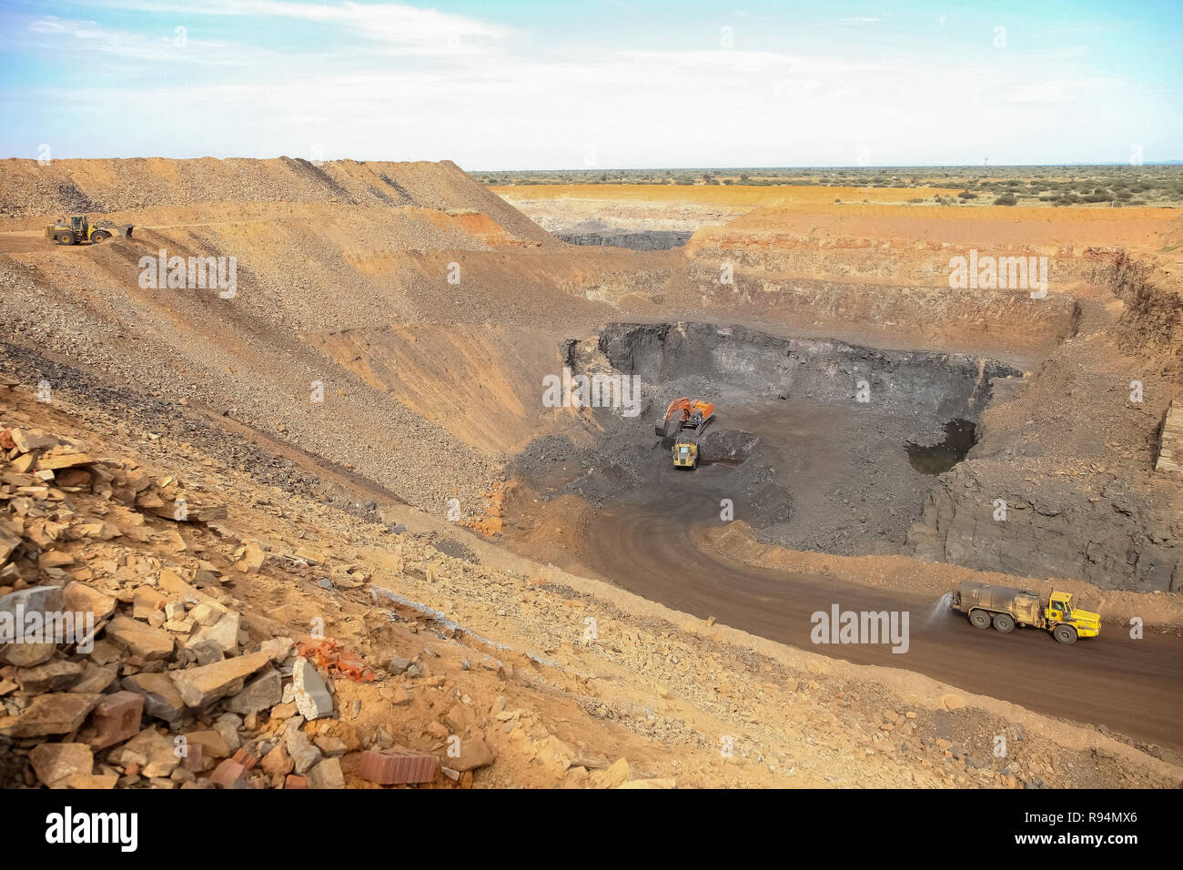 Open pit Manganese Mining - Excavator digging out ore rich rock and ...