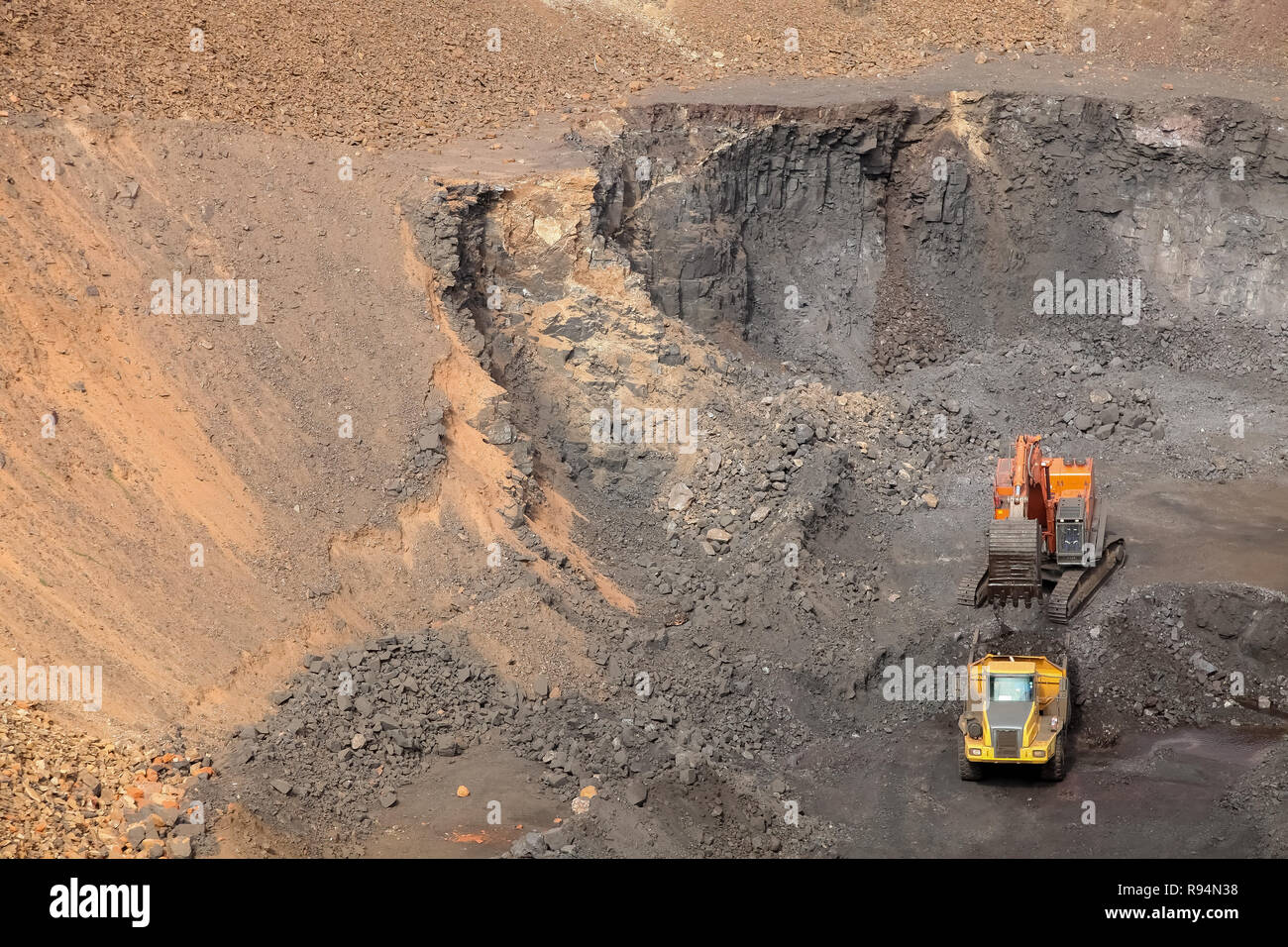 Open pit Manganese Mining - Excavator digging out ore rich rock and ...