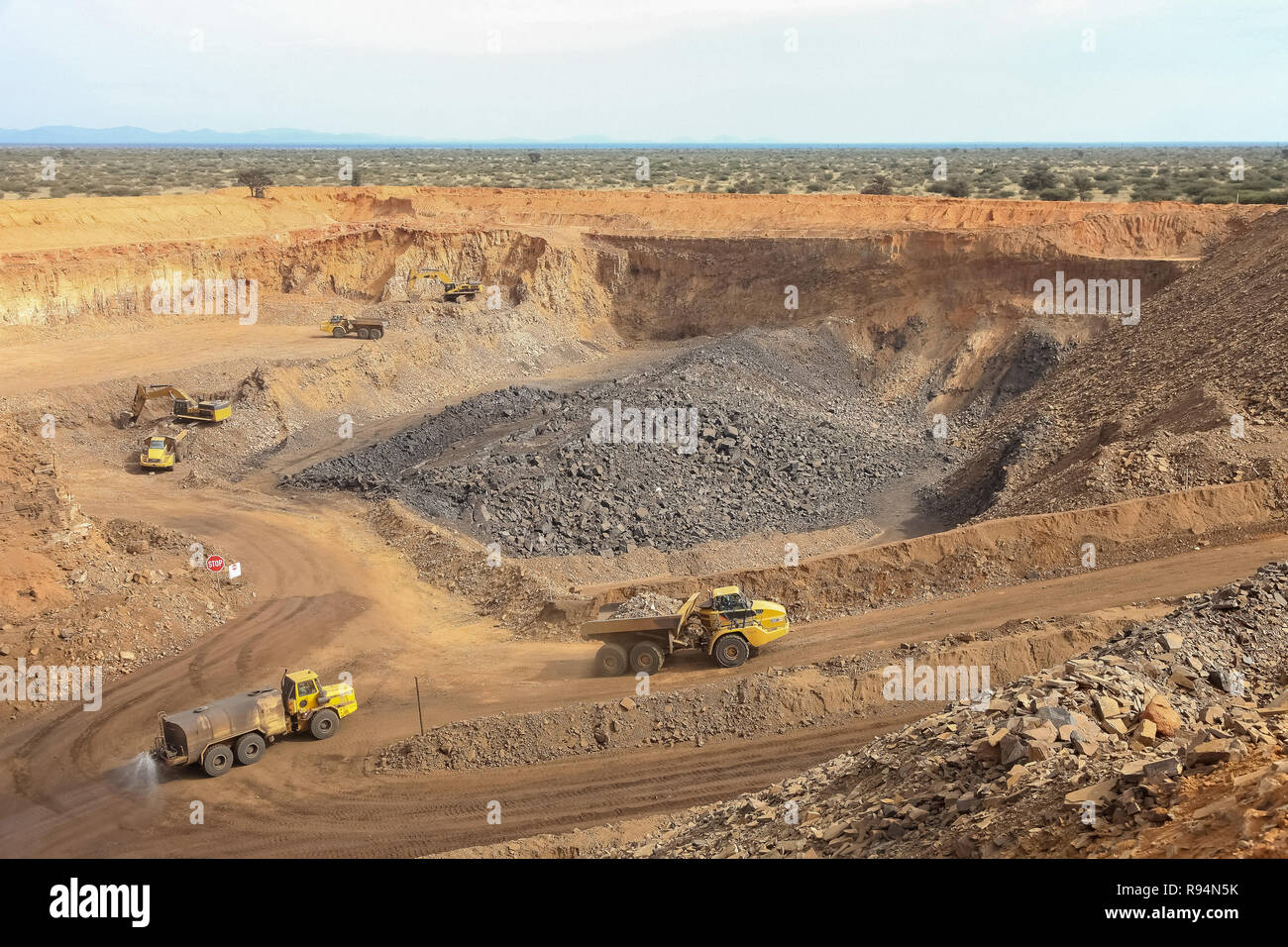 Open pit Manganese Mining - Excavator digging out ore rich rock and ...