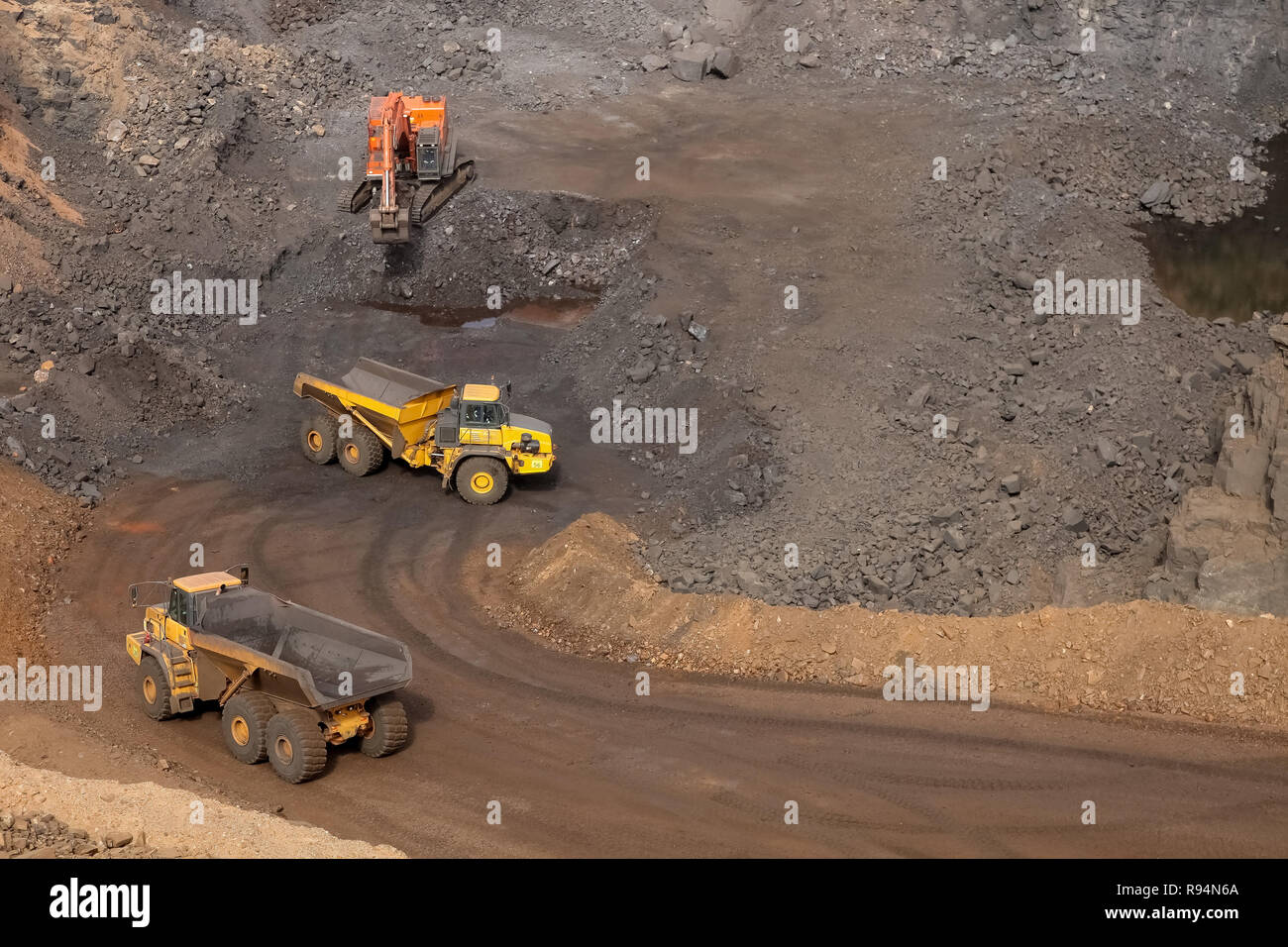 Open pit Manganese Mining - Excavator digging out ore rich rock and ...