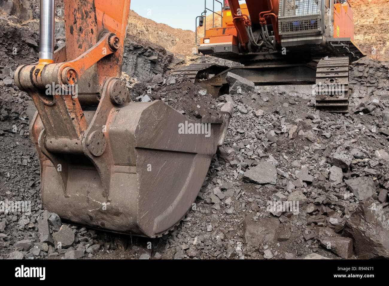 Open pit Manganese Mining - Excavator digging out ore rich rock and ...
