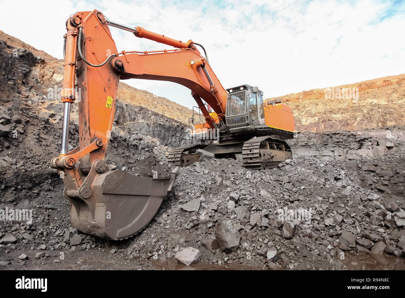 Open pit Manganese Mining - Excavator digging out ore rich rock and ...