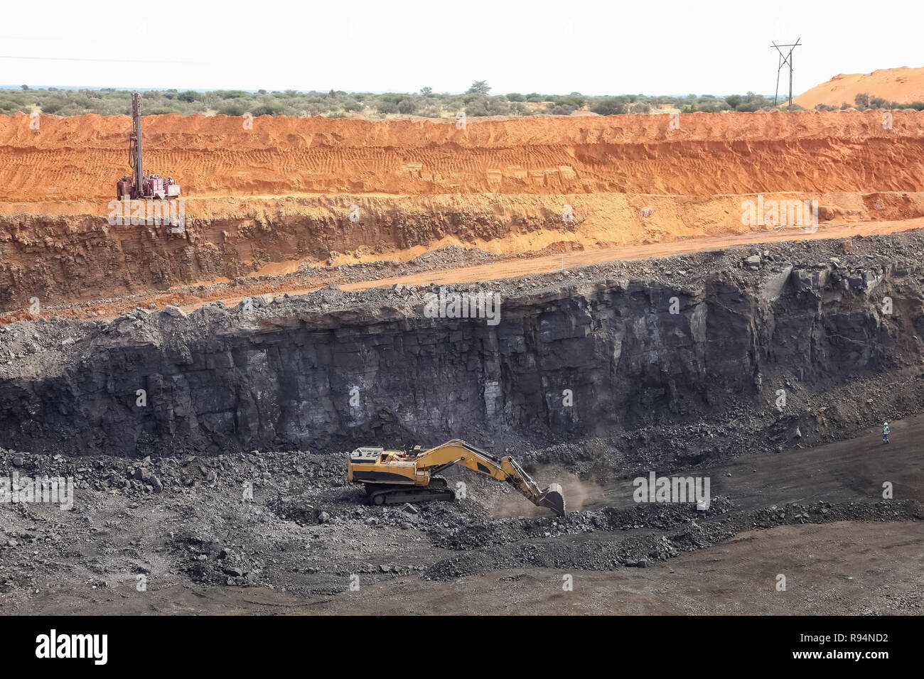 Open pit Manganese Mining - Excavator digging out ore rich rock and ...