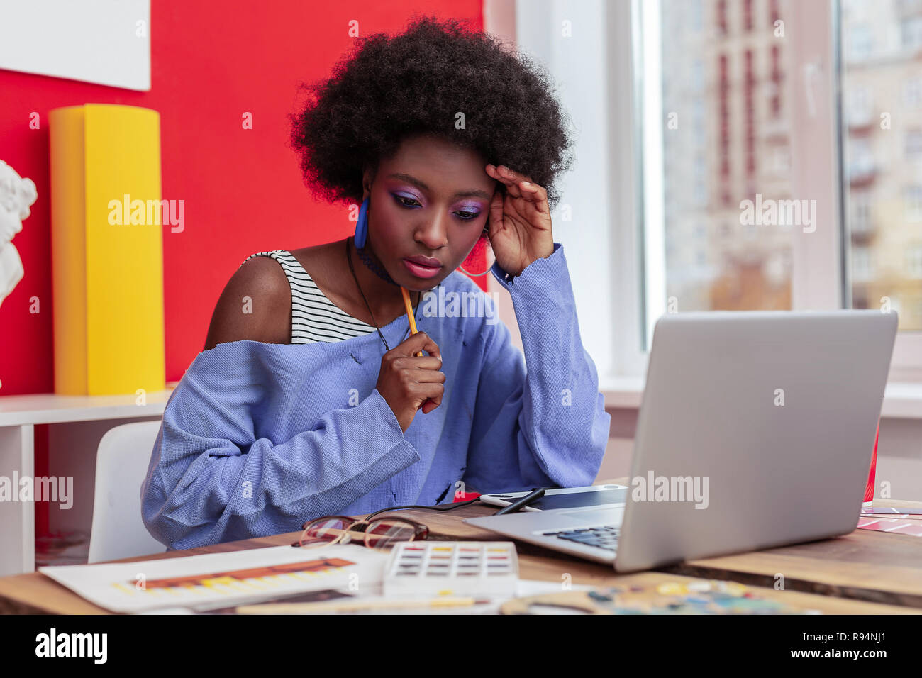 International student feeling busy writing e-mail to her professor ...