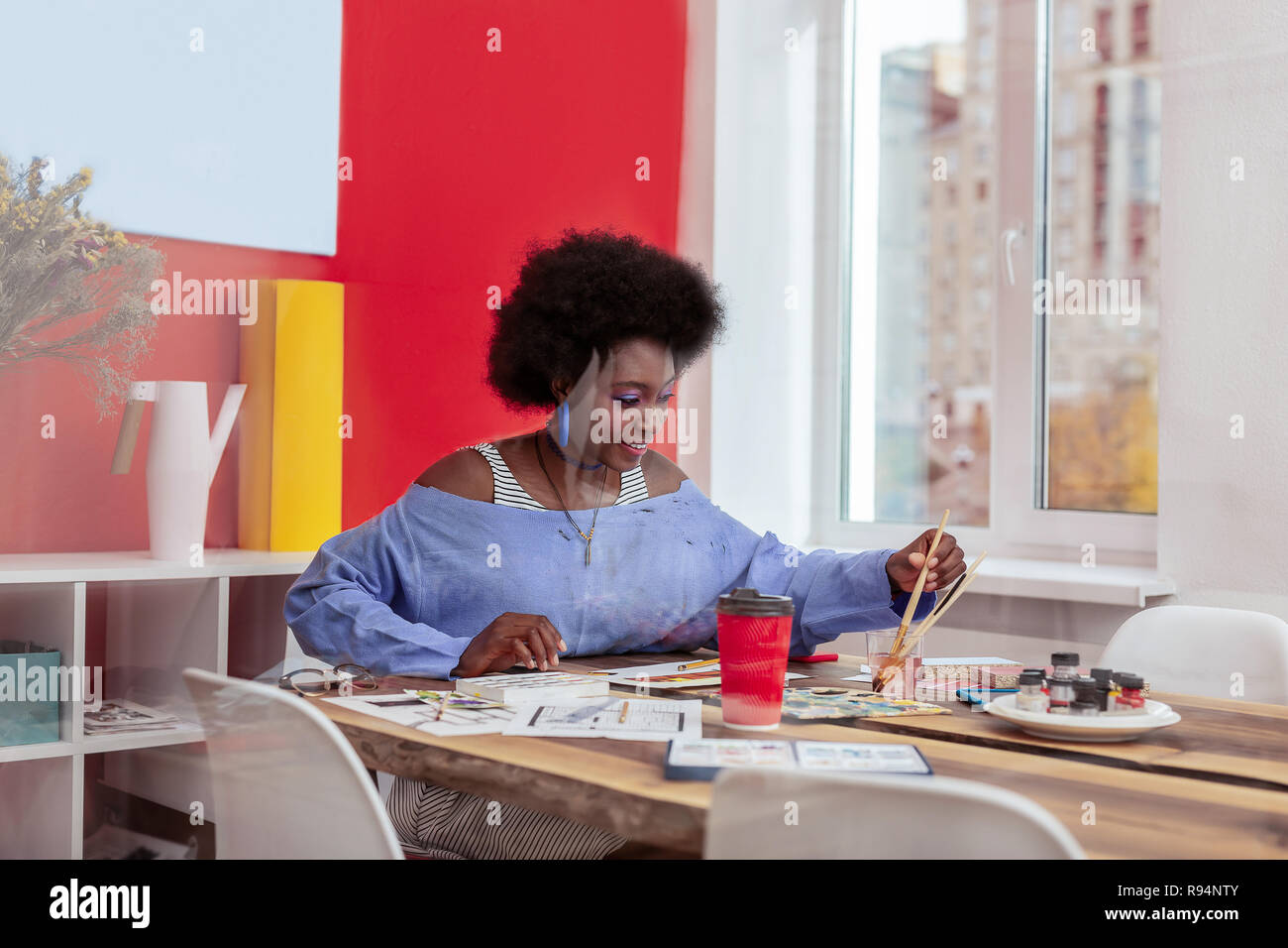 Young promising artist feeling inspired and joyful while working Stock ...