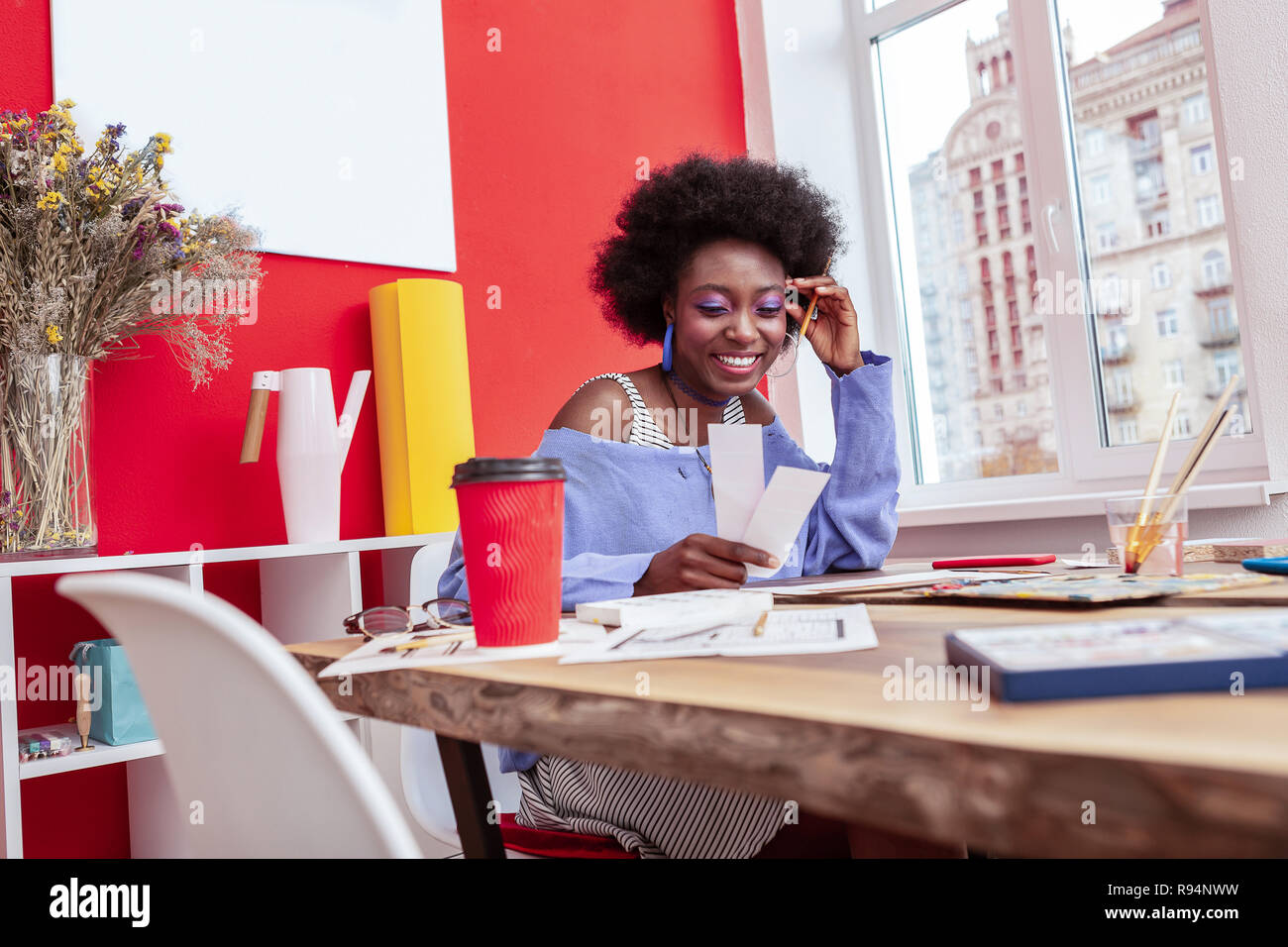 Creative inspired fashion designer drinking coffee and working Stock ...