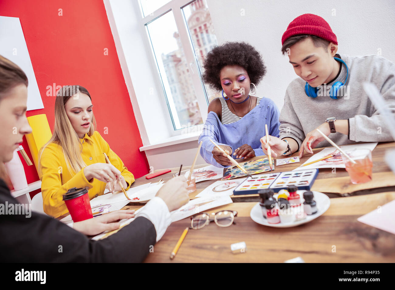 Art students learning painting techniques while working together Stock ...