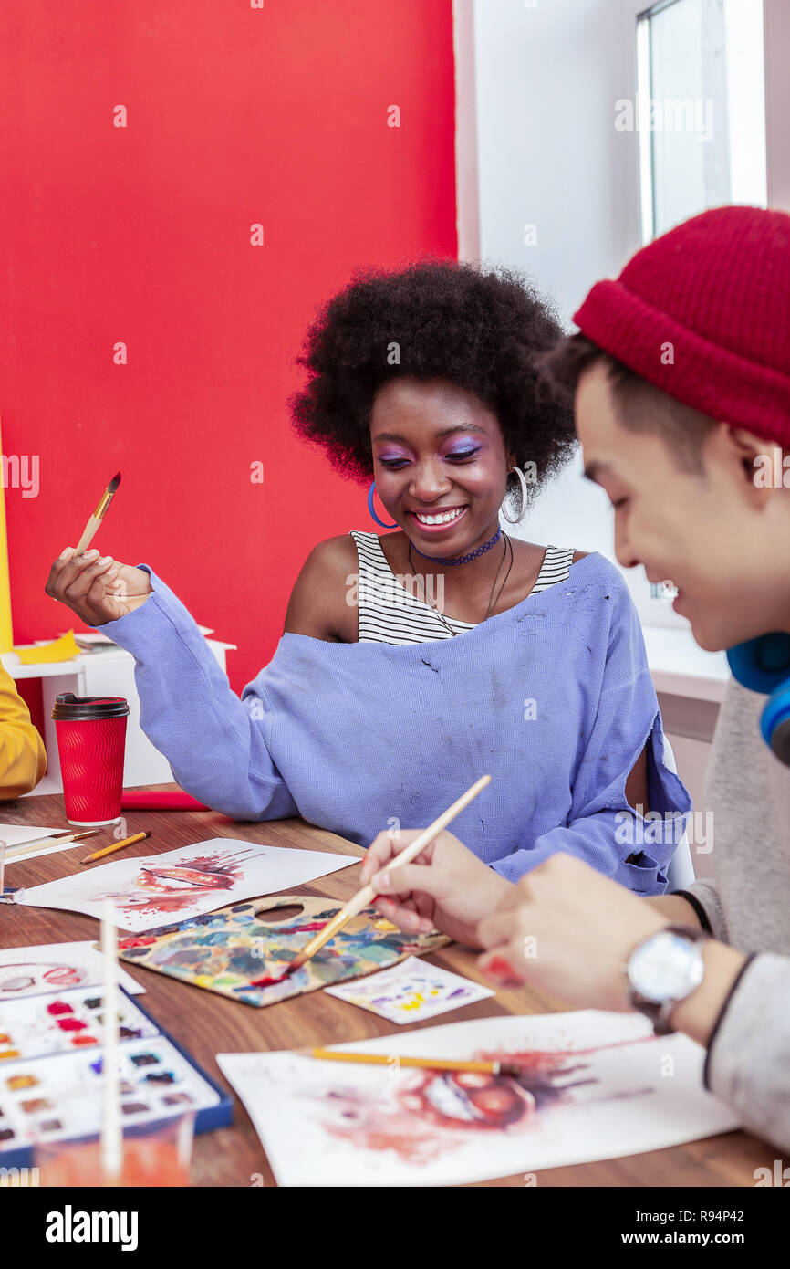 Cheerful international student with bright makeup smiling broadly Stock ...