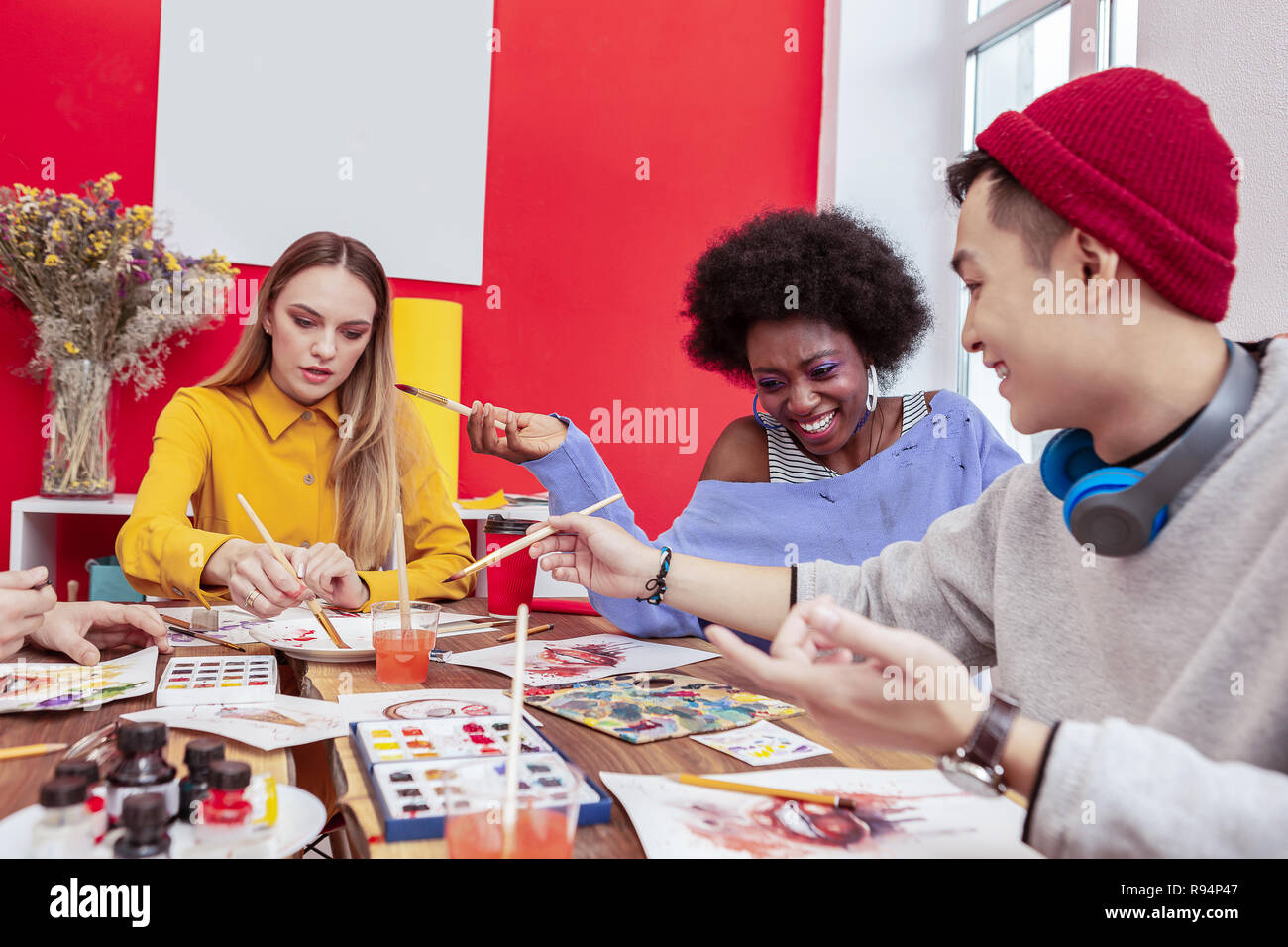 Three art students involved in preparing to important presentation ...