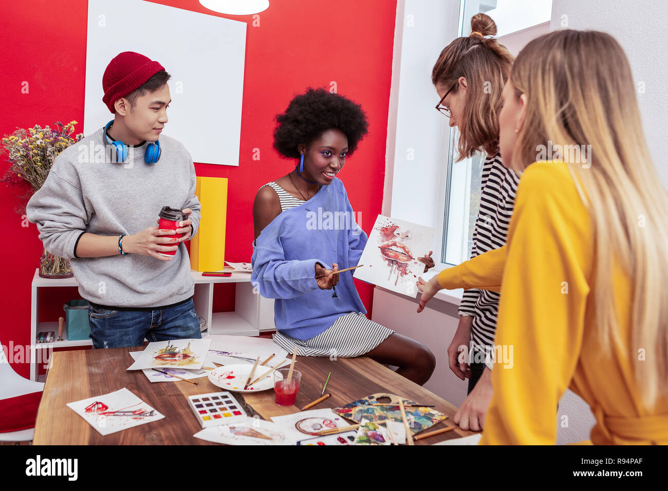 African-American art student sharing her work with colleague Stock ...