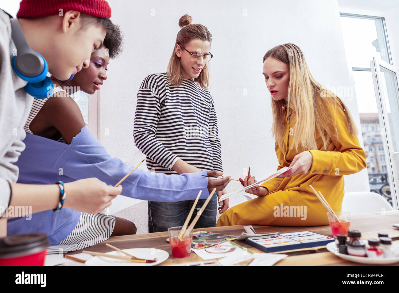 Four students of art school feeling joyful while studying Stock Photo ...