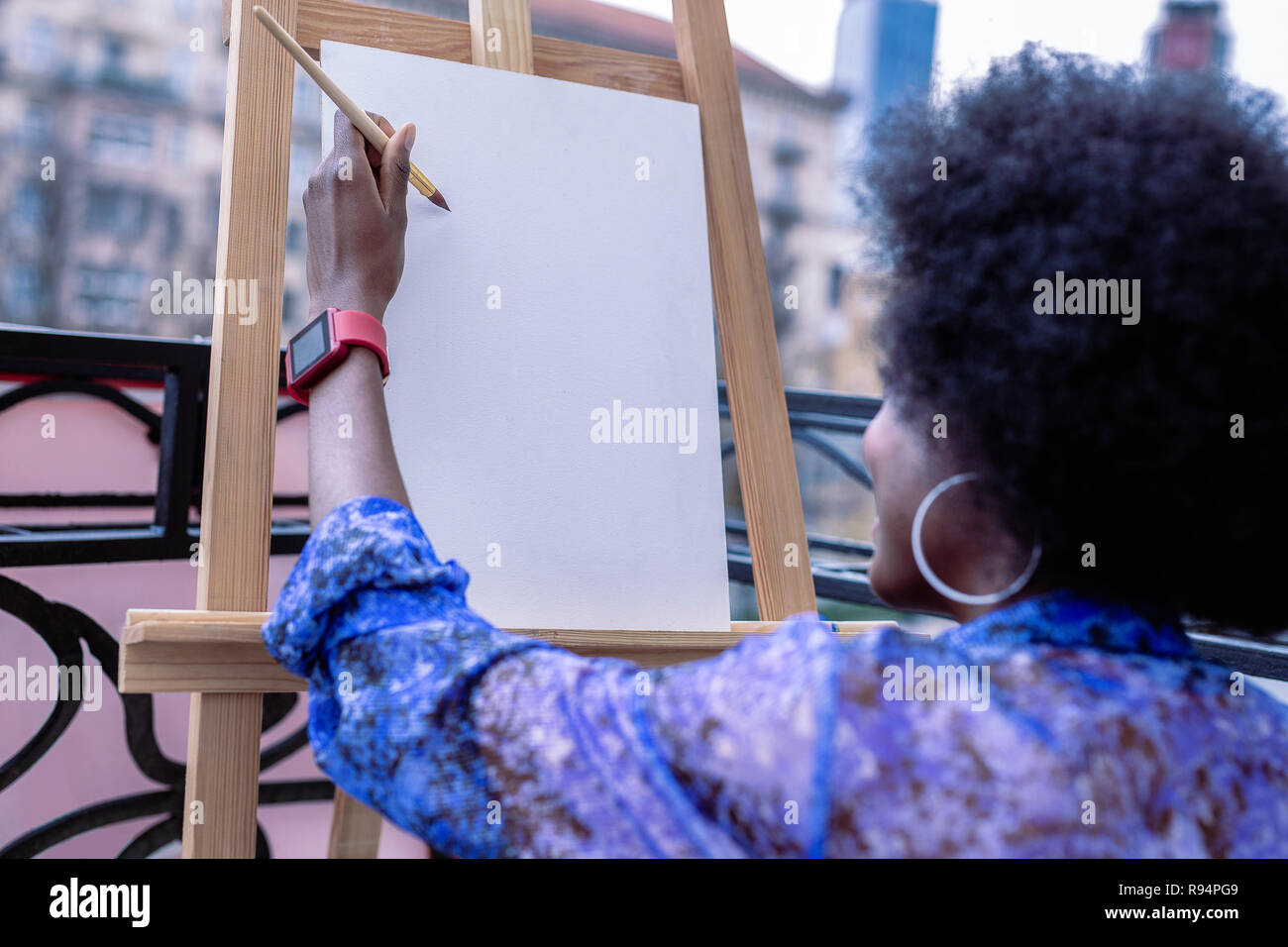 African-American artist wearing red smart watch working outside Stock ...
