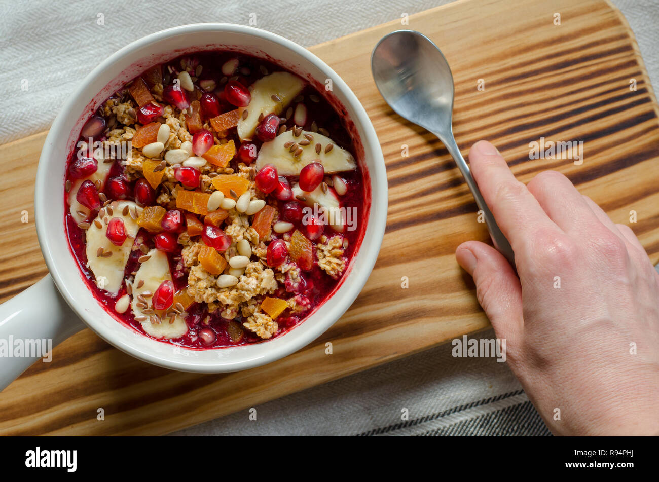 Smoothie acai bowl topped with pomegranate, bananas, flaxseeds, cedar ...
