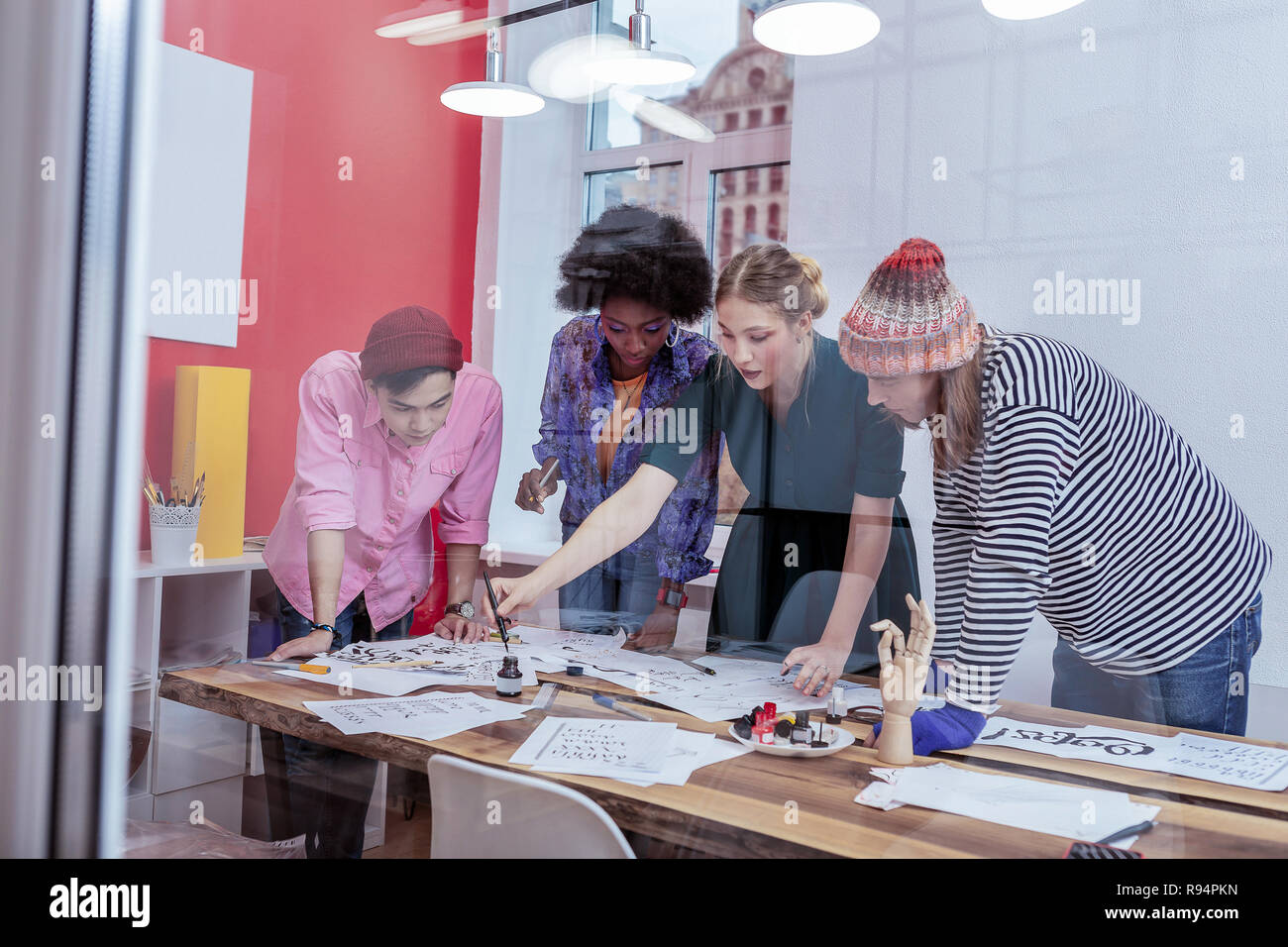Four workers of fashion magazine working on new project Stock Photo - Alamy