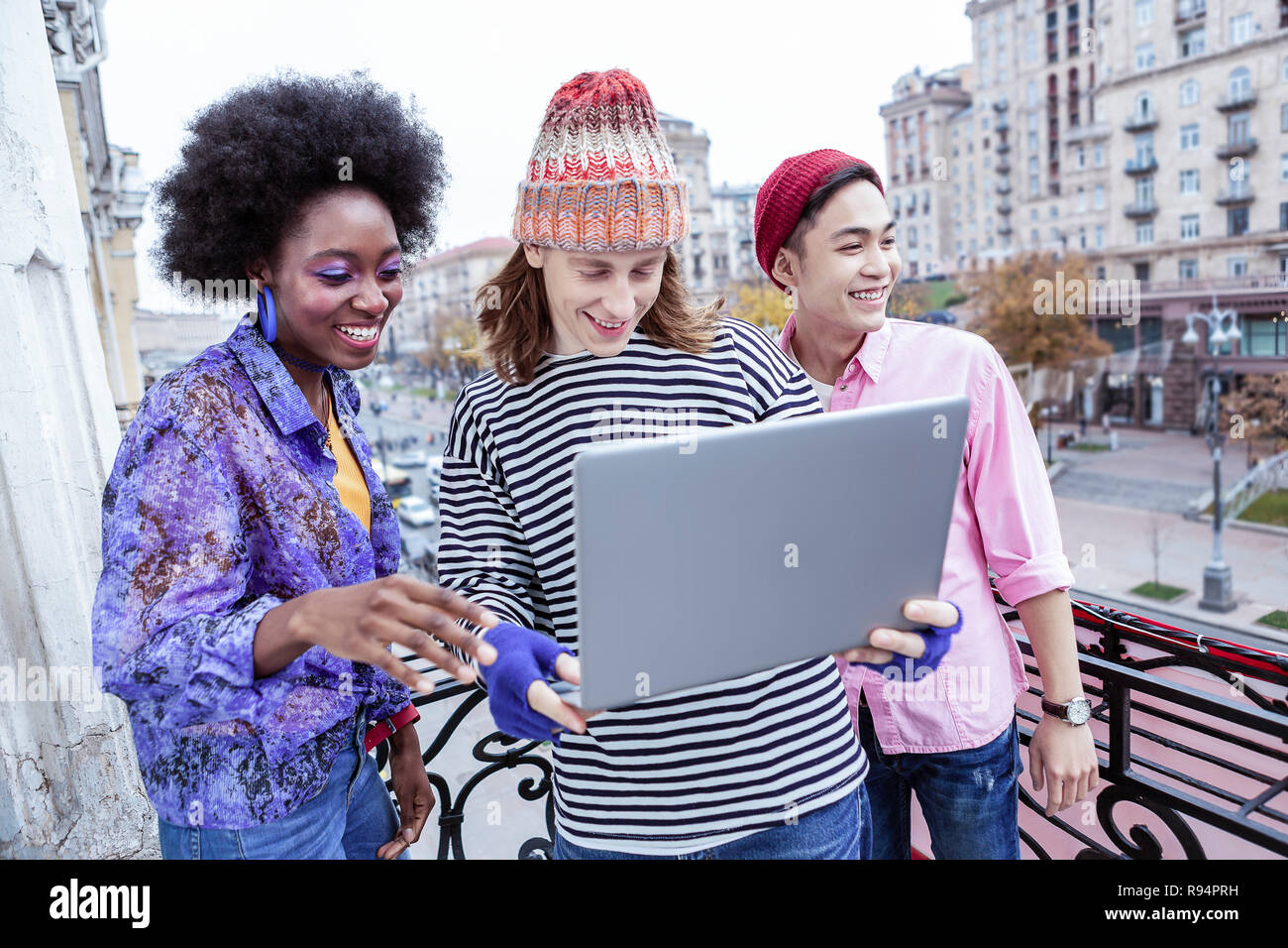 Programmer with long blonde hair showing his project to friends Stock ...