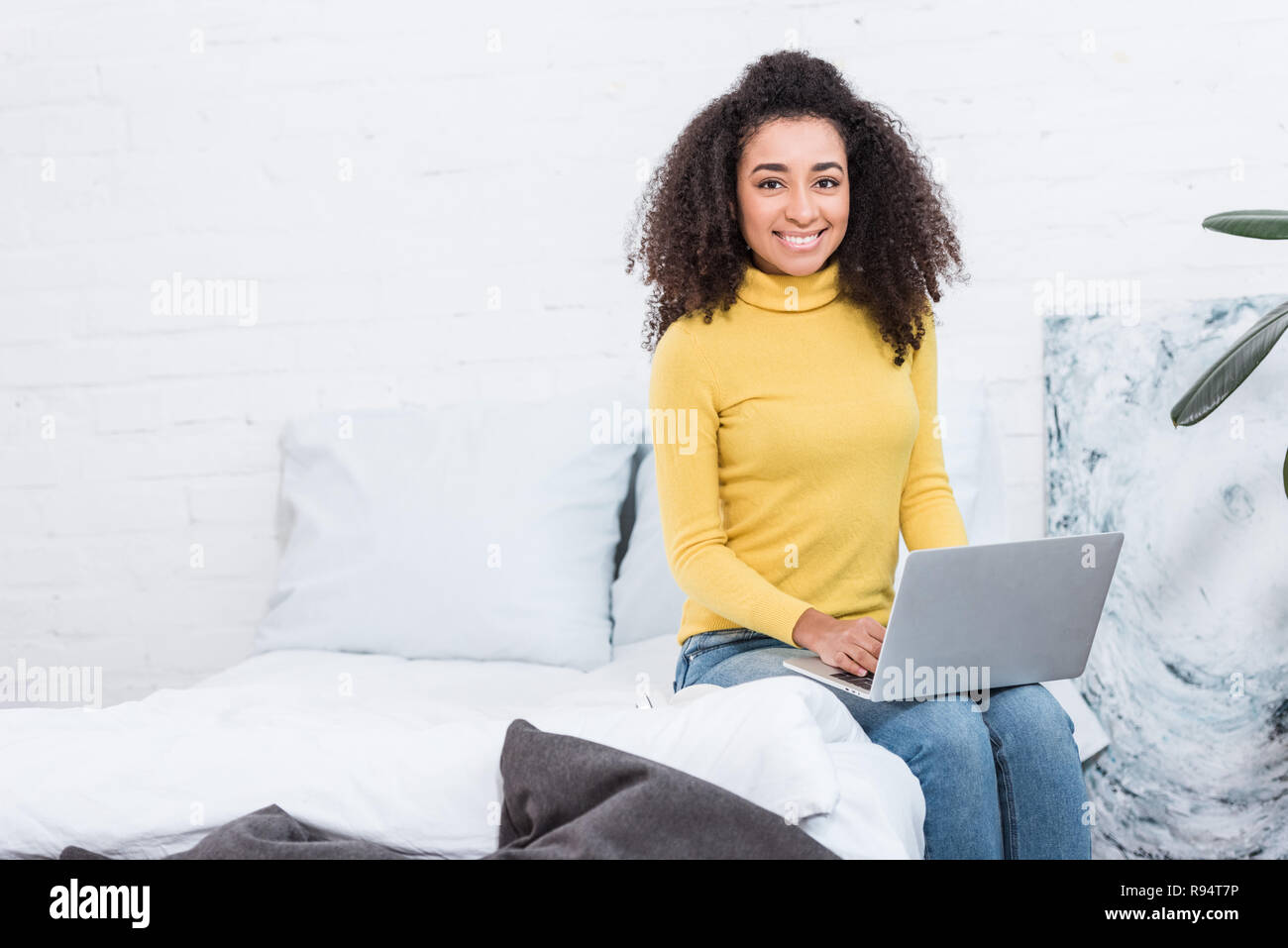 curly beautfiul female freelancer working on laptop at home Stock Photo ...