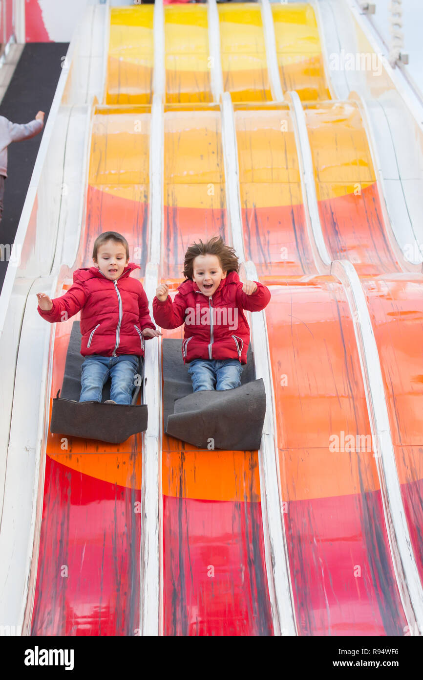 Happy children, going down huge slide, happy, enjoying the ride Stock ...