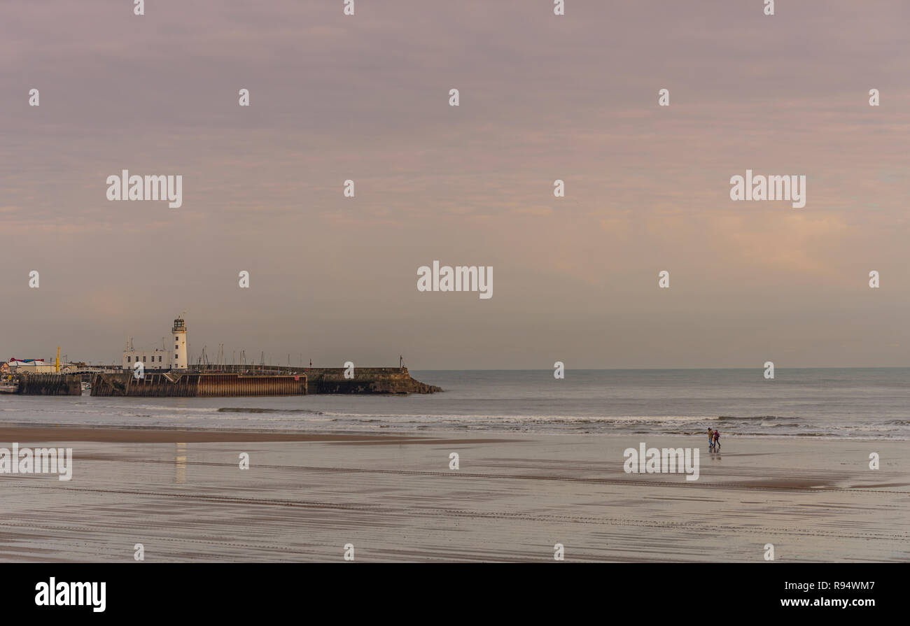 The beach and coast at Scarborough on a moody morning with the ...
