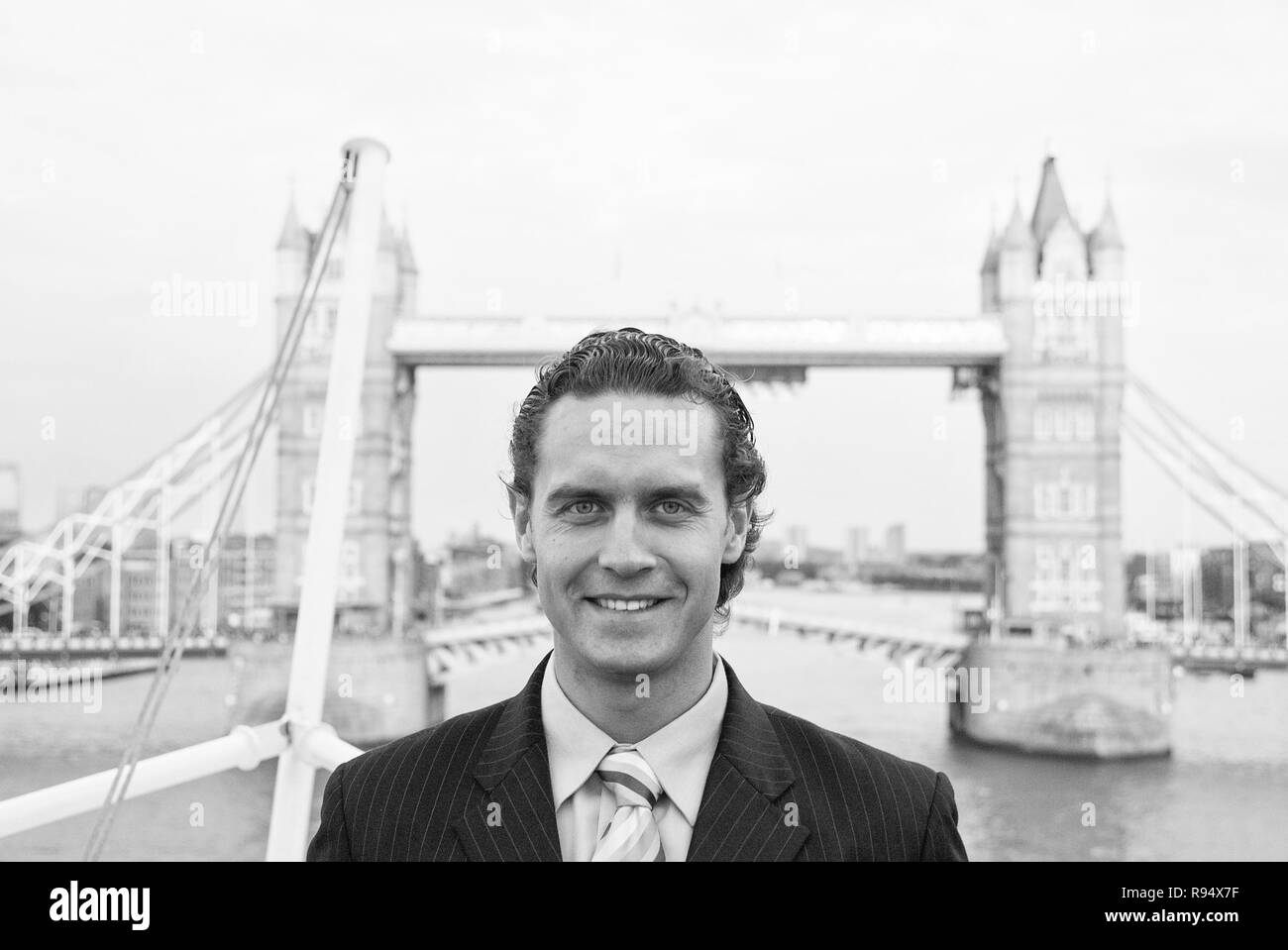 Man smile in London, United Kingdom. Happy businessman at Tower bridge ...