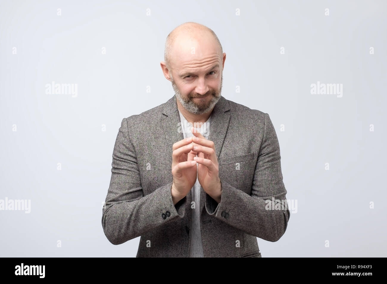 Cunning tricky mature man thinking with hand together over white ...