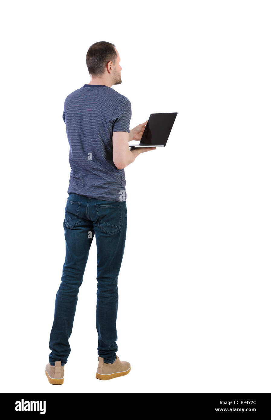 Back view of a man who is standing with a laptop. Rear view people ...
