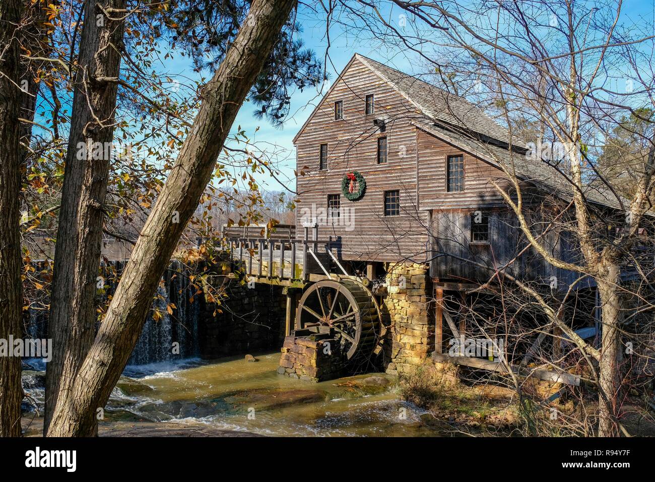 Old mill decorated with a holiday wreath for Christmas as seen through ...