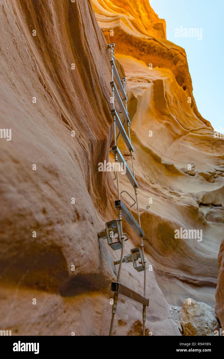 Metal ladder attached to rocks in Red Canyon. Red Canyon is one of ...