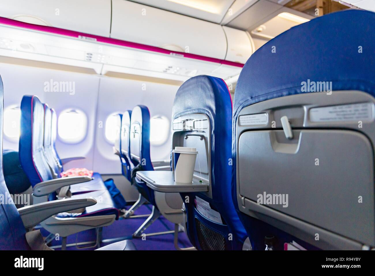 Seats and cup of tea in passenger airplane. Passenger plane interior ...