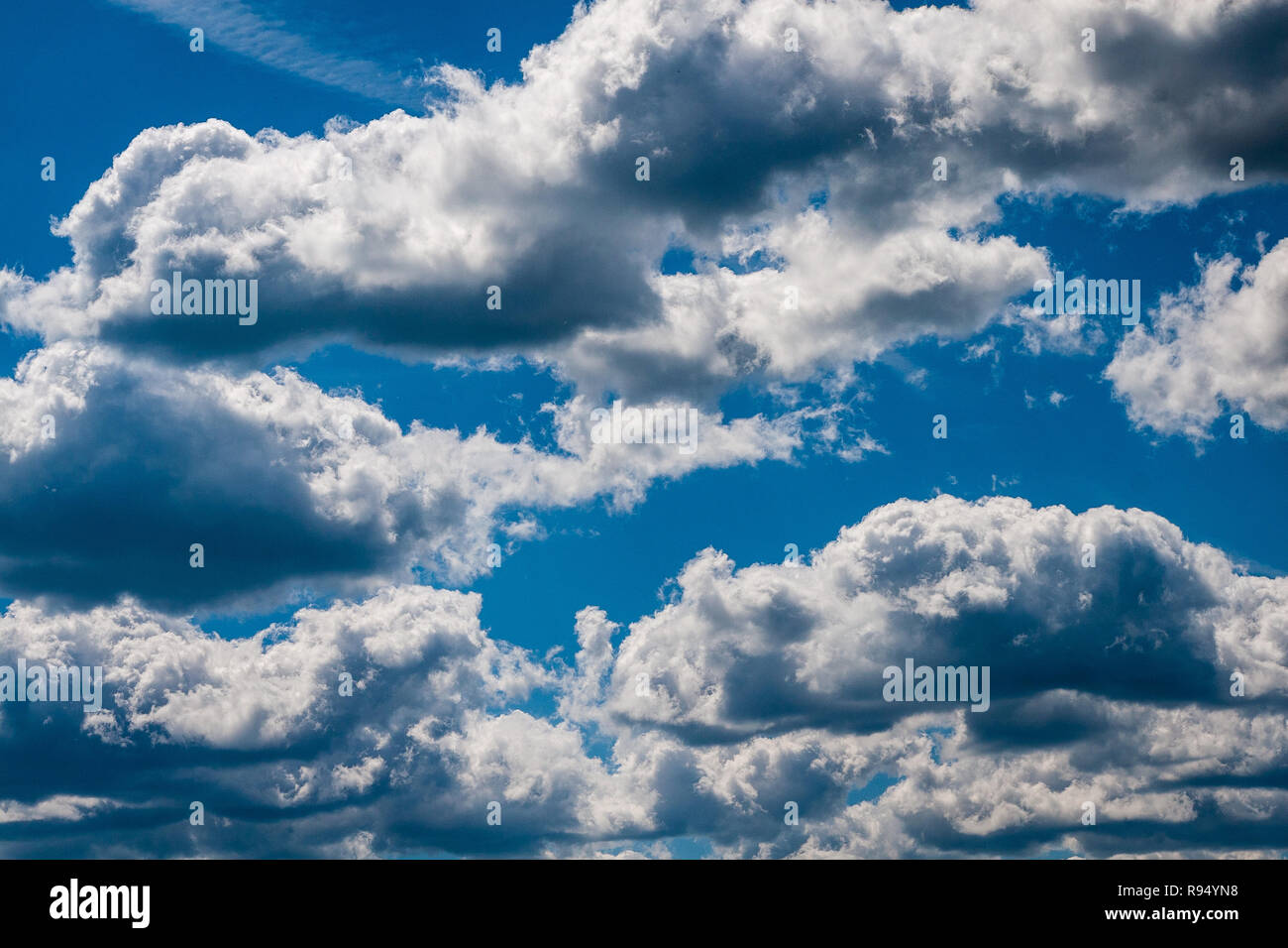 high contrast clouds on blue sky over natural landscape in summer at ...