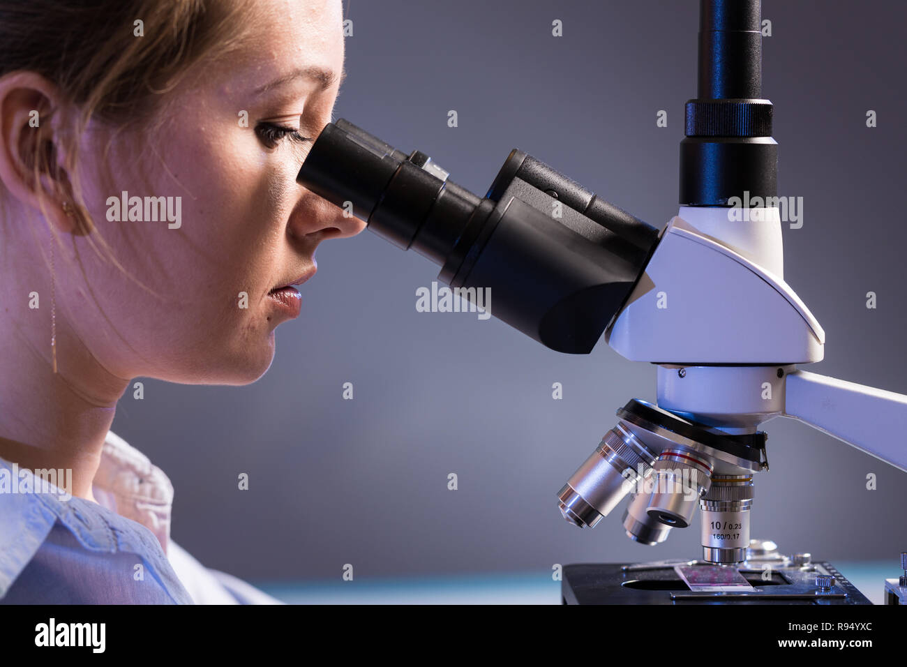 Man looking glass microscope hi-res stock photography and images - Alamy