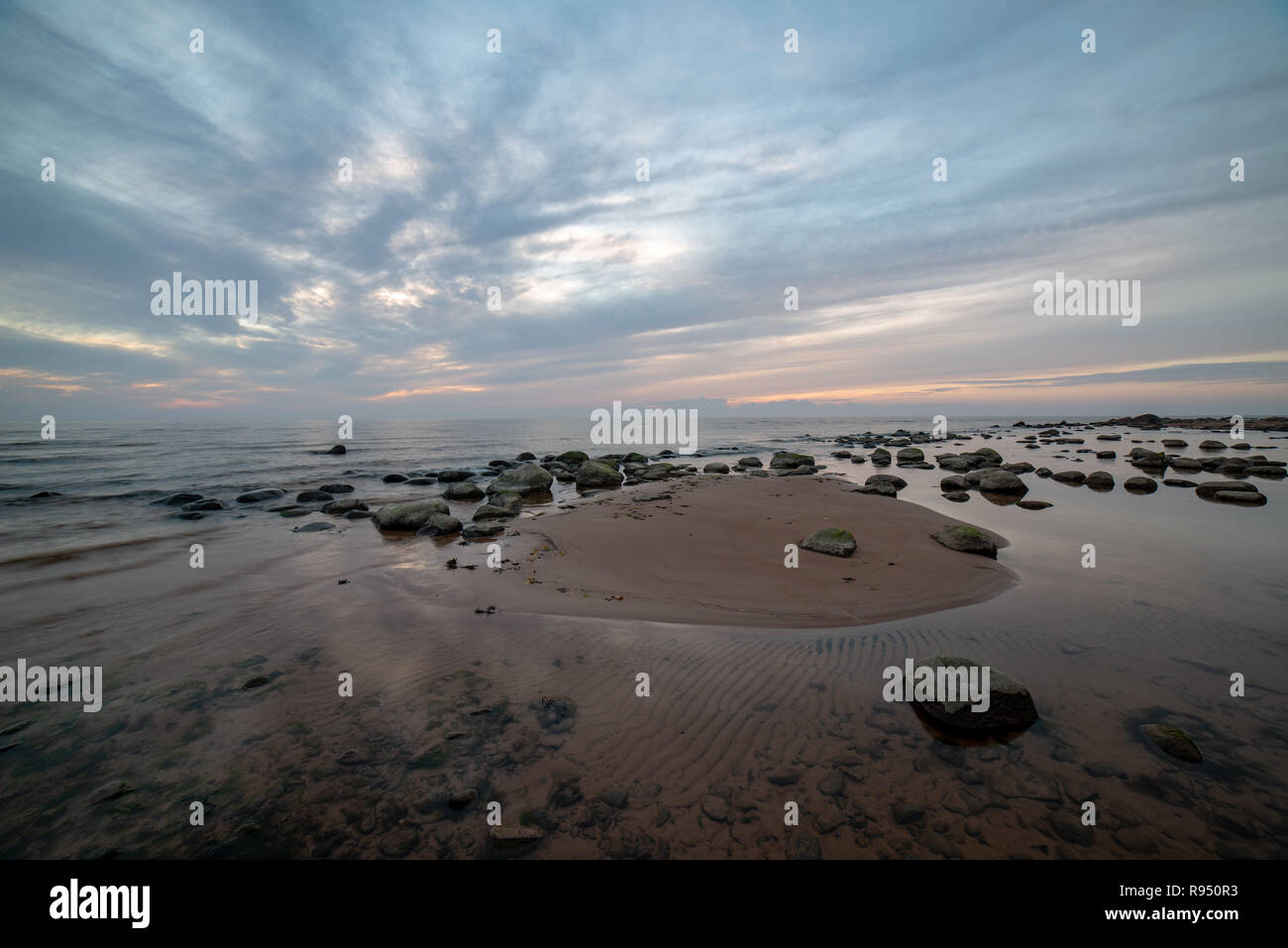 dramatic high contrast clouds in sunset over seaside beach with sand ...
