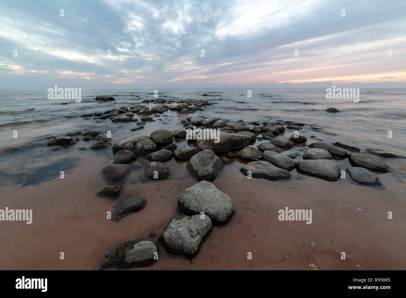dramatic high contrast clouds in sunset over seaside beach with sand ...