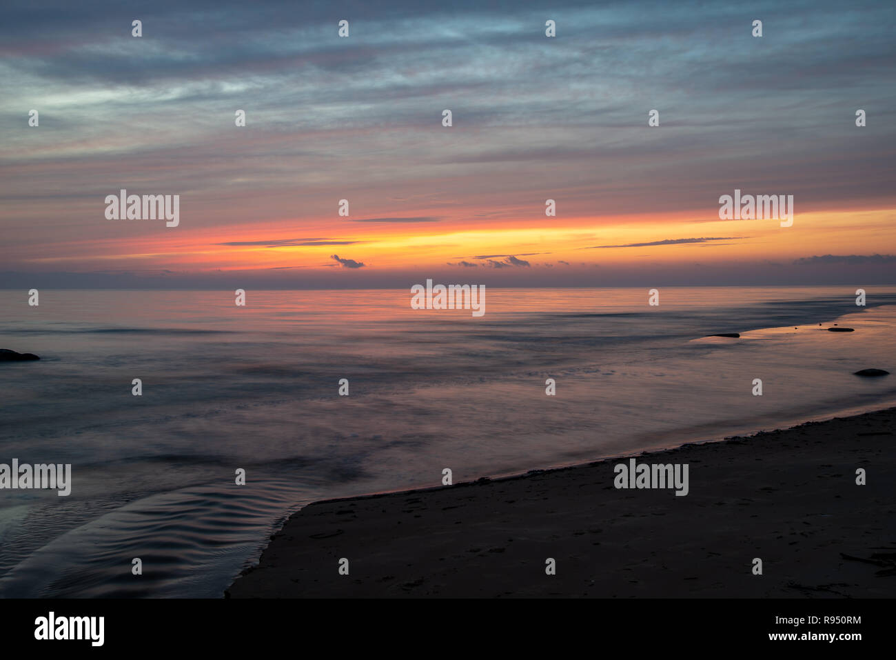 dramatic high contrast clouds in sunset over seaside beach with sand ...