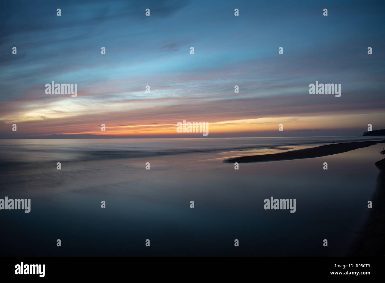 dramatic high contrast clouds in sunset over seaside beach with sand ...