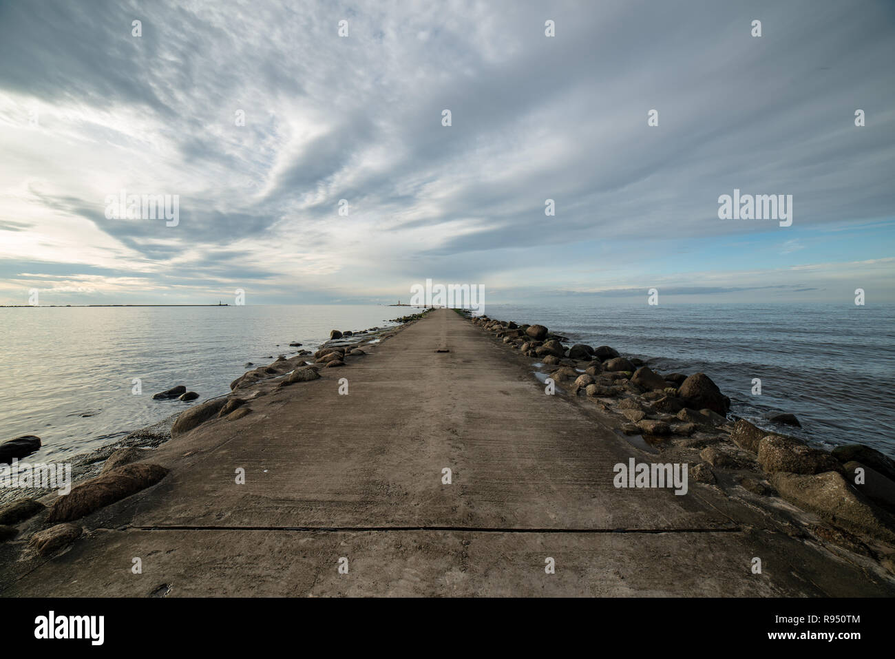 dramatic high contrast clouds in sunset over seaside beach with sand ...