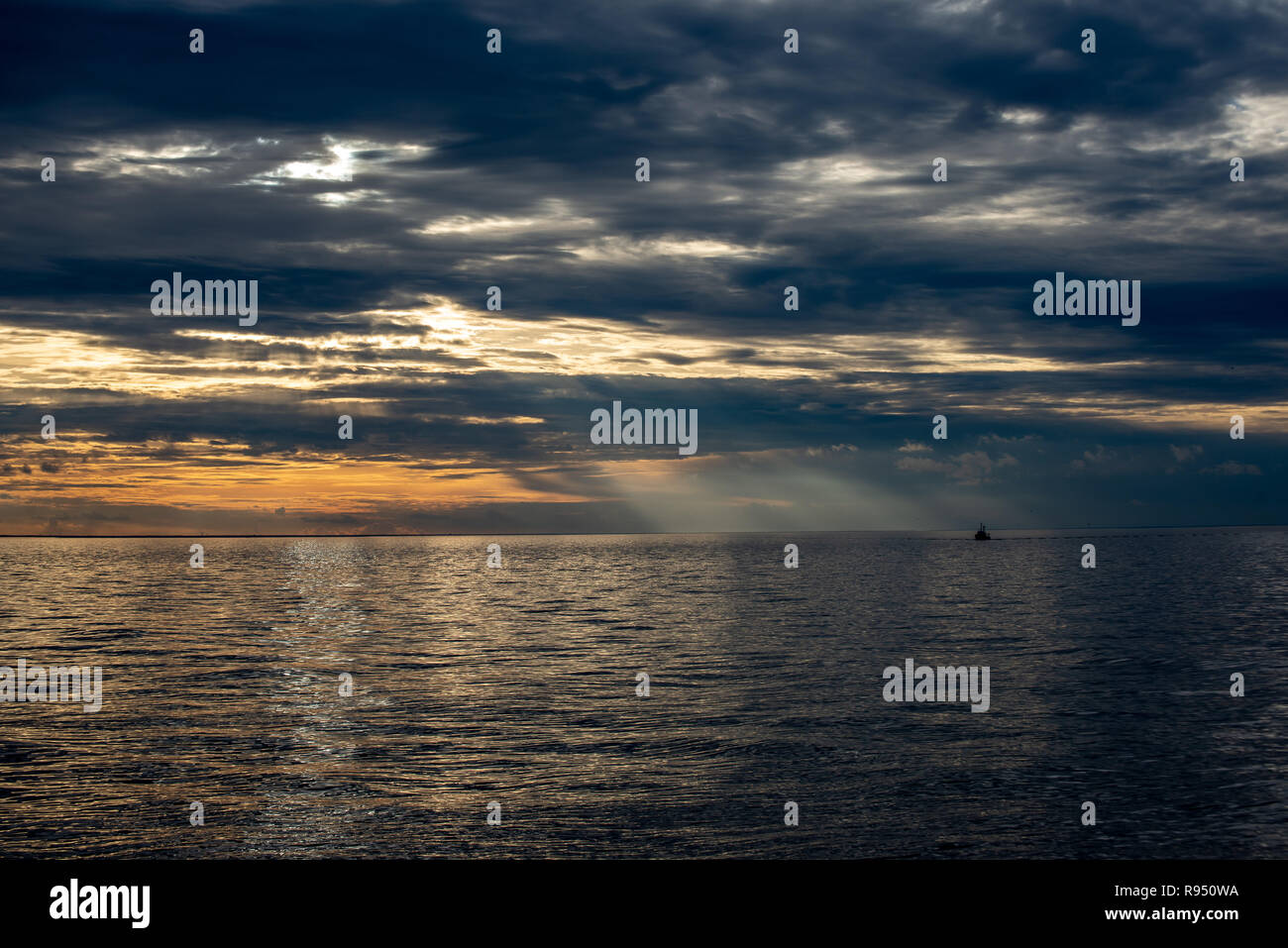 dramatic high contrast clouds in sunset over seaside beach with sand ...
