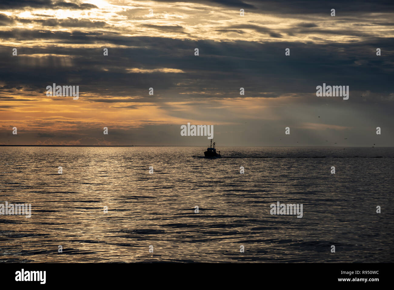 dramatic high contrast clouds in sunset over seaside beach with sand ...