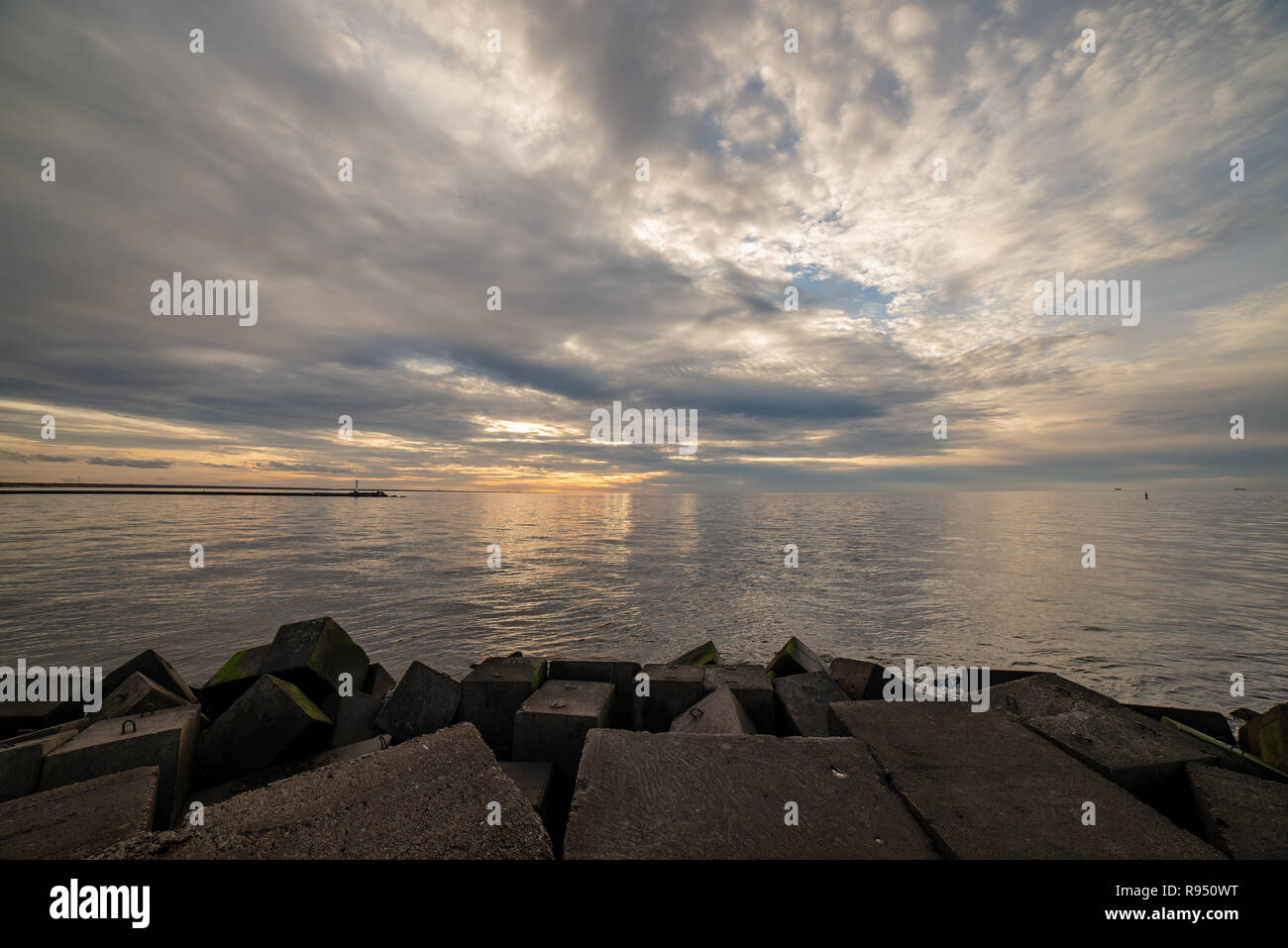 dramatic high contrast clouds in sunset over seaside beach with sand ...