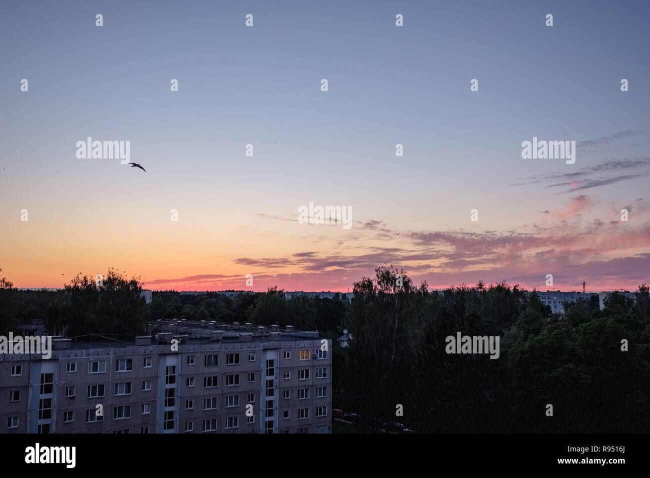 dramatic clouds on red sky over city roof tops at sunset Stock Photo ...