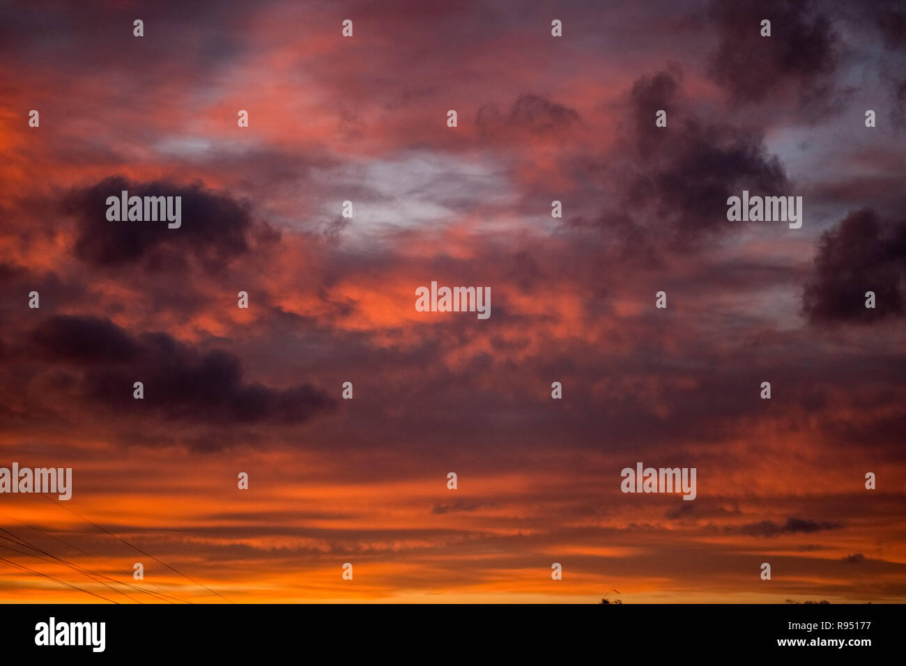dramatic high contrast clouds in sunset over seaside beach with sand ...