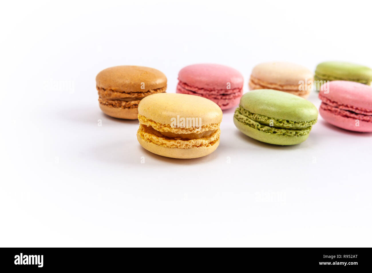 Colorful French macarons closeup isolated on white background with copy ...