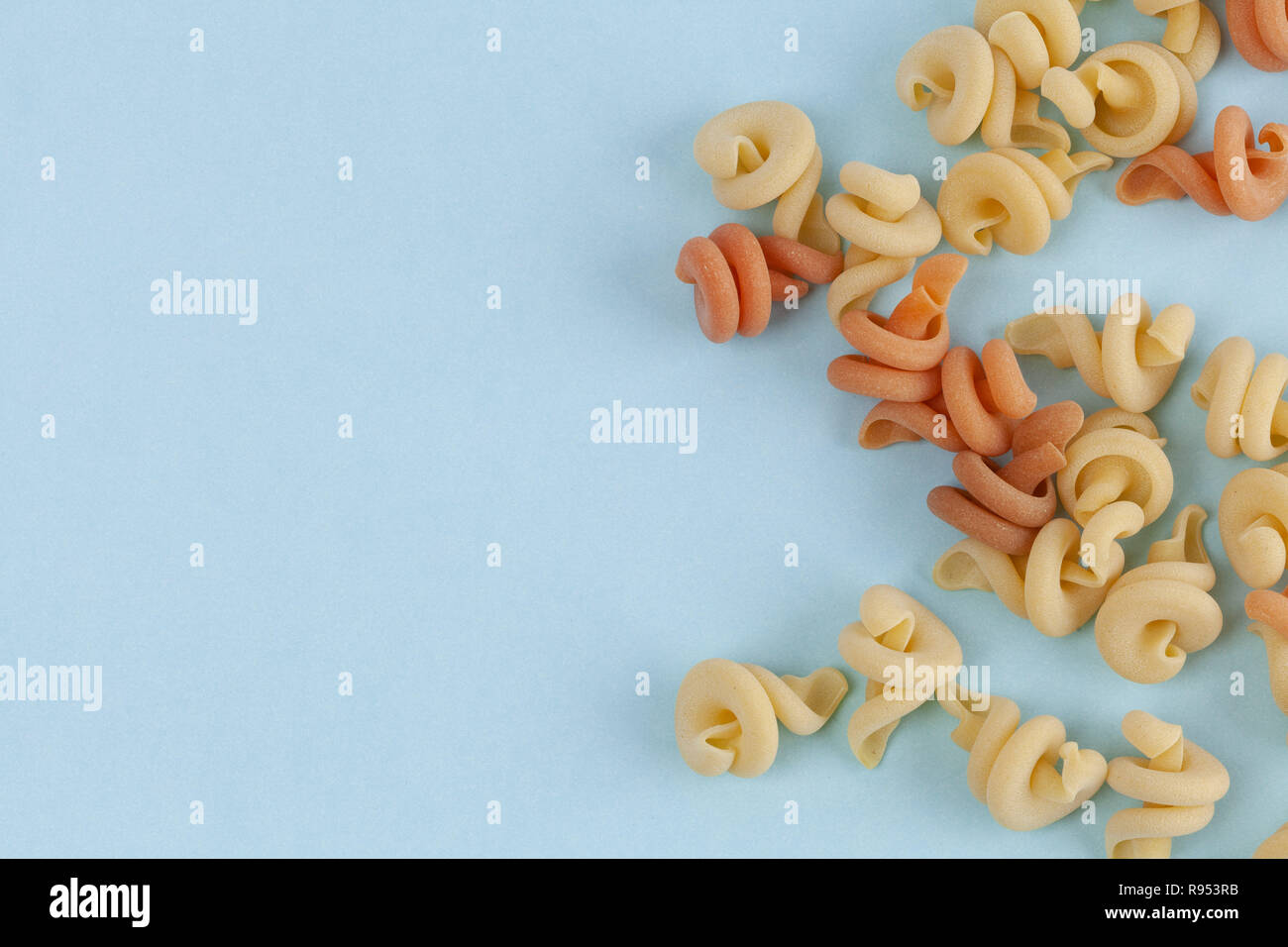 Funghetto pasta noodles on blue background with copy space Stock Photo ...