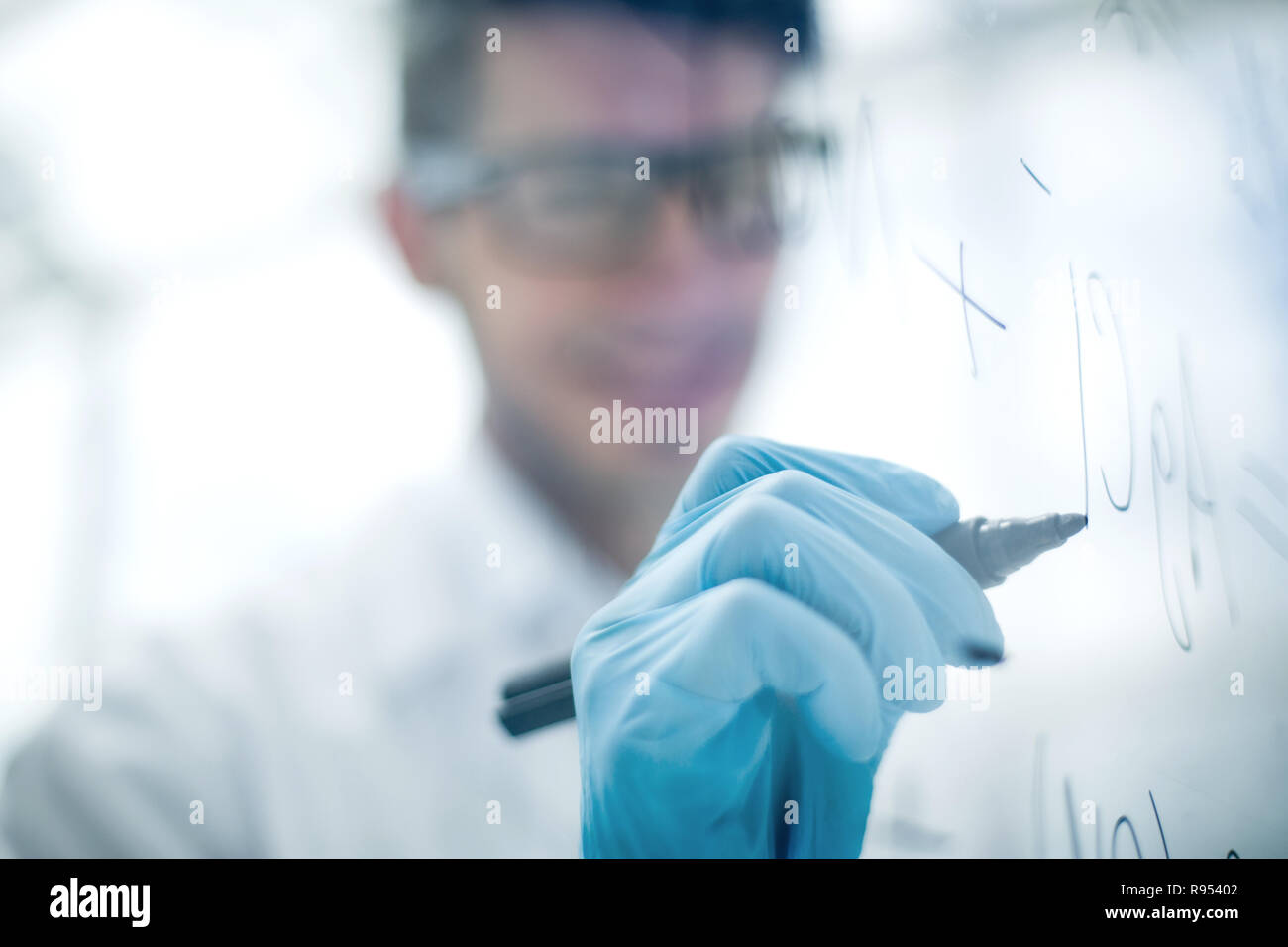 background image.the scientist writes on a glass Board Stock Photo - Alamy