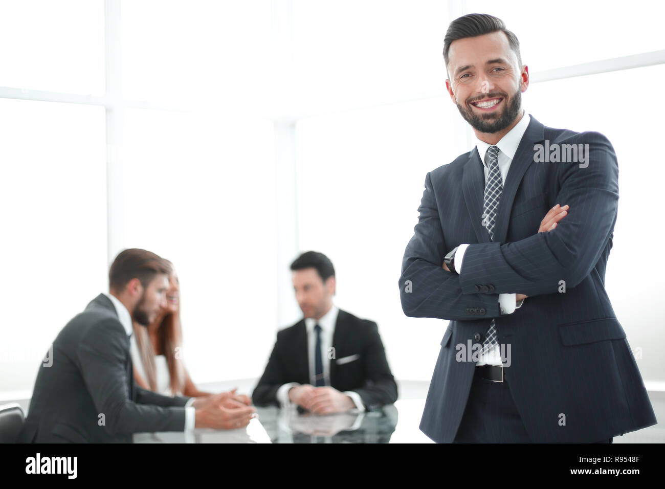 successful business man standing in a bright office Stock Photo - Alamy
