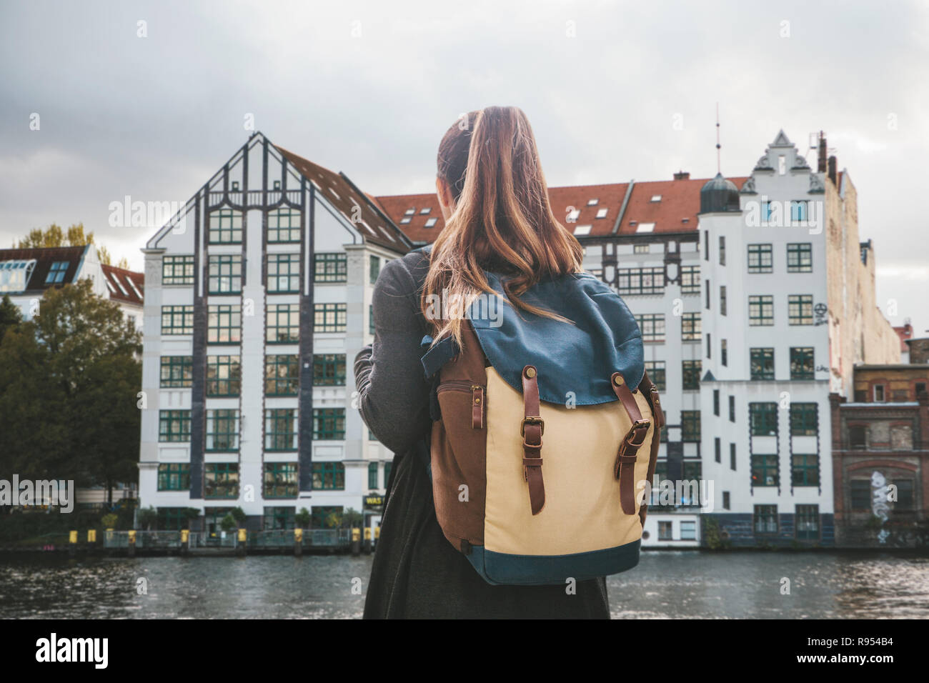 Tourist girl with a backpack or a student looks at the sights in Berlin ...