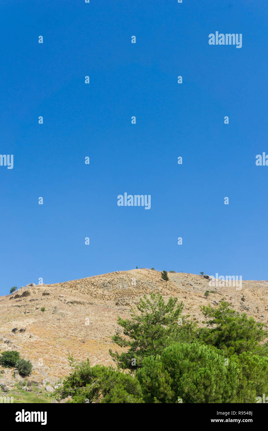 View of green trees, mountains and blue clear sky in summer on the ...