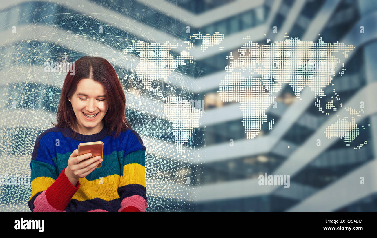 Cheerful woman colorful sweater holding smartphone browsing internet ...