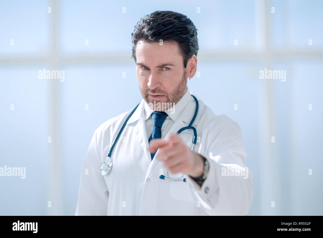 attentive doctor pointing finger at you Stock Photo - Alamy