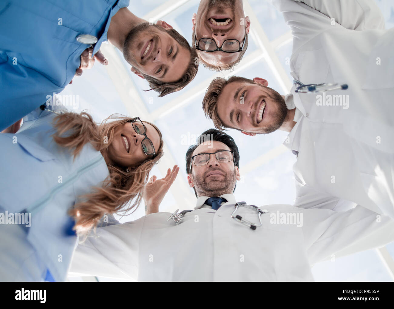 doctors looking down smiling at the camera Stock Photo - Alamy